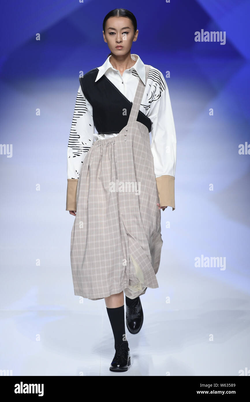 A model displays a new creation at the fashion show of Asahi Kasei ...