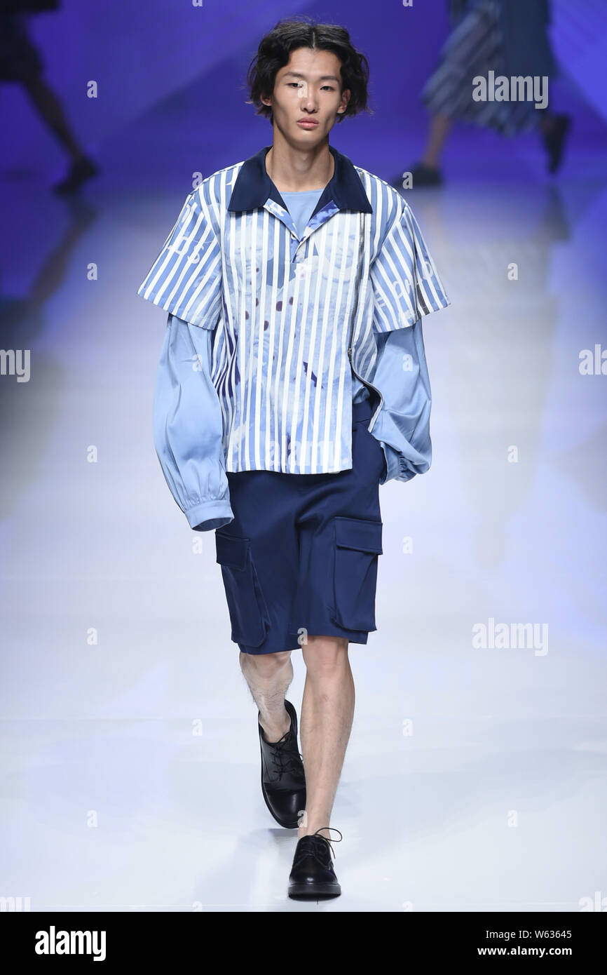 A model displays a new creation at the fashion show of Asahi Kasei ...