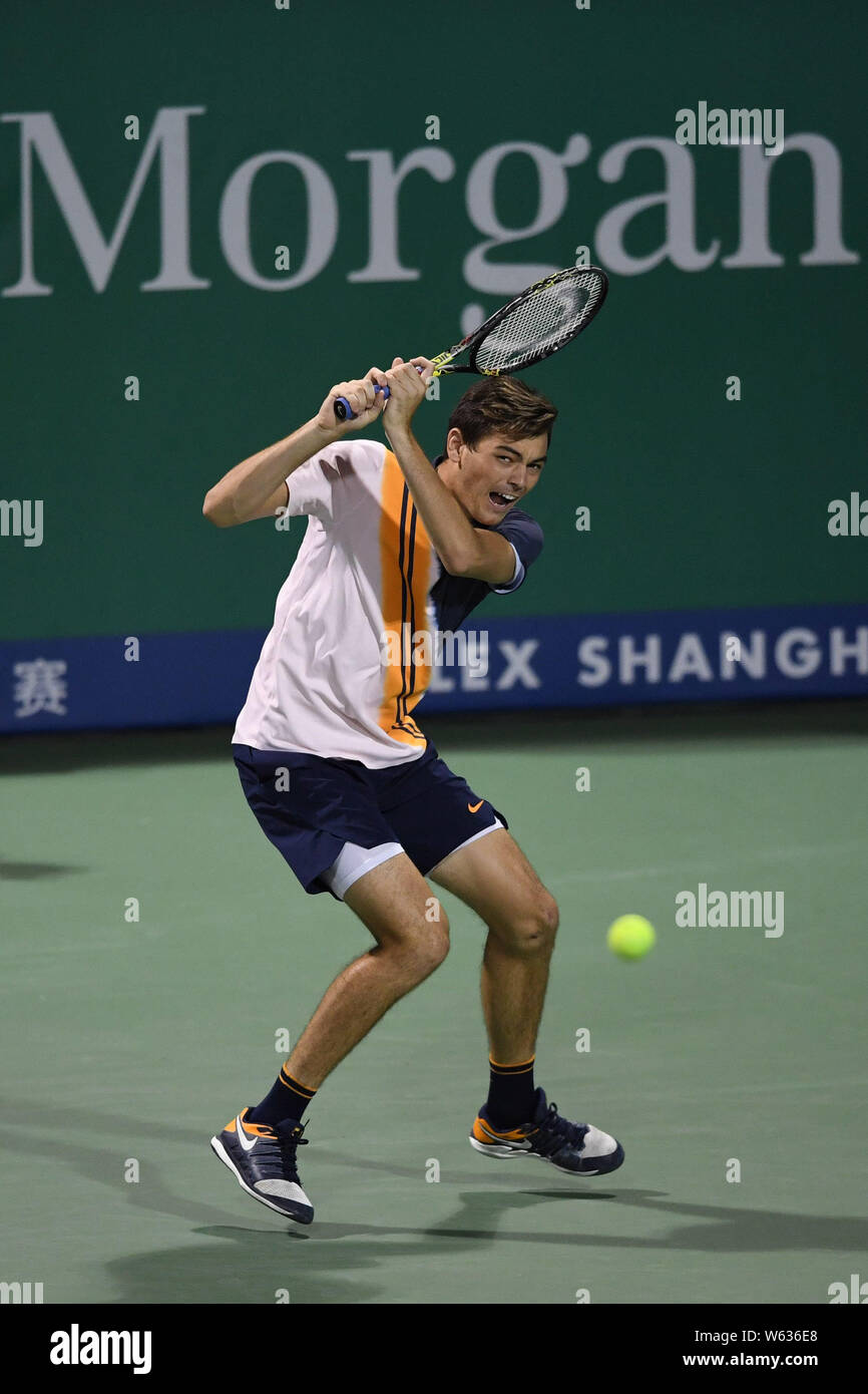 Taylor Fritz of the United States returns a shot to Sam Querrey of the ...