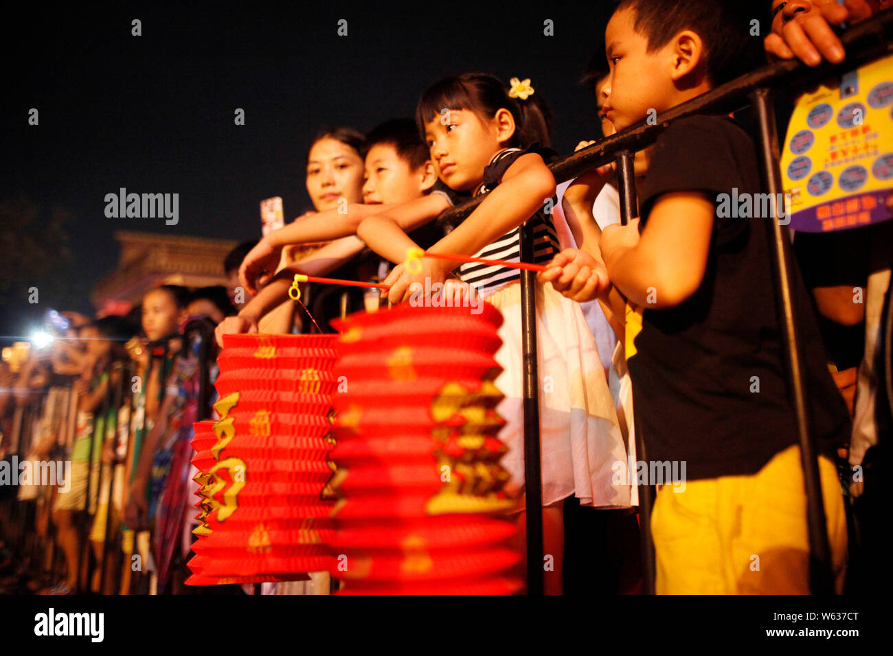 Local residents gather to watch a pagoda made of tile bricks on fire to ...