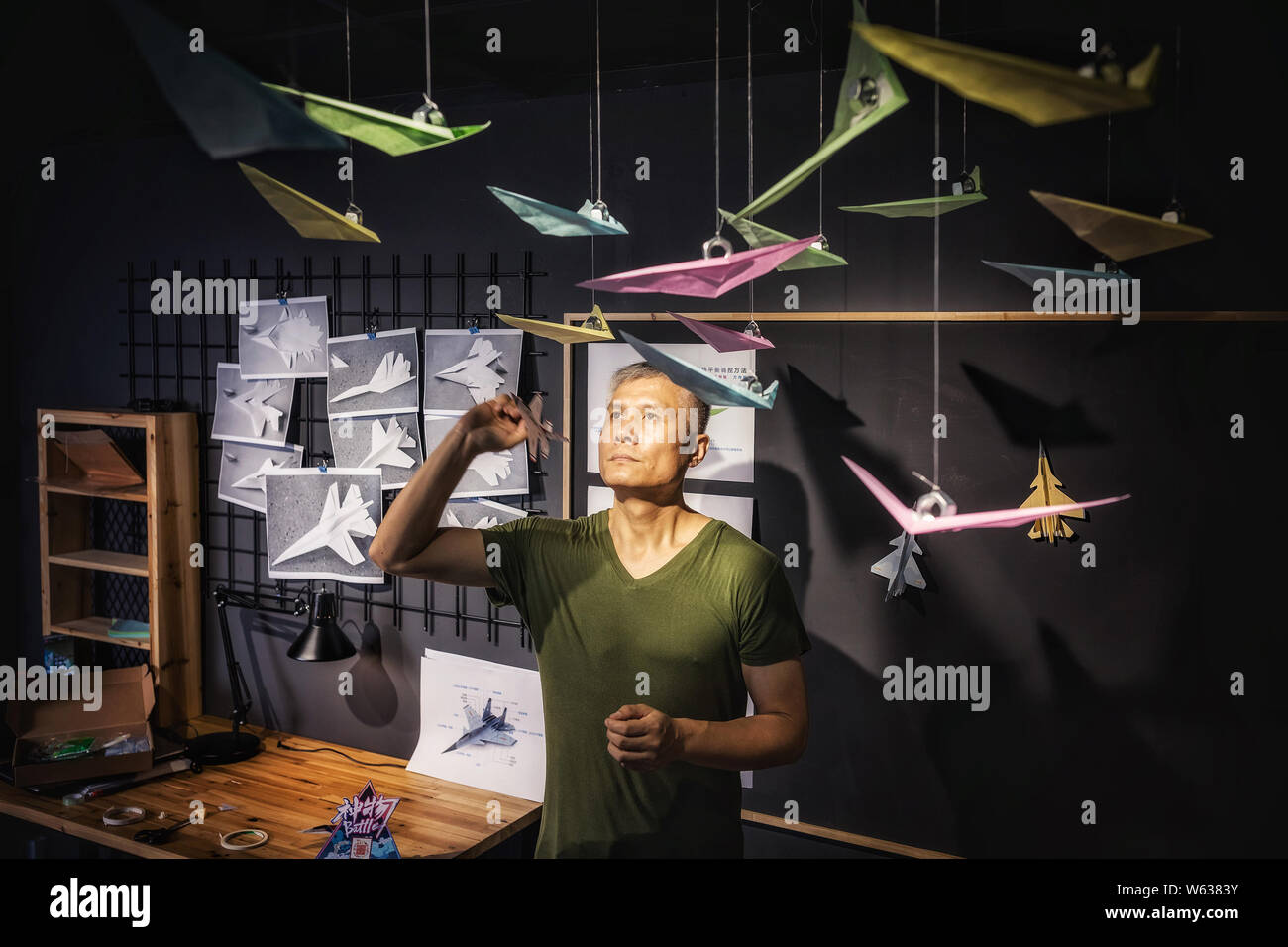 Chinese paper plane maker Liu Dong shows his paper jets at the stall ...