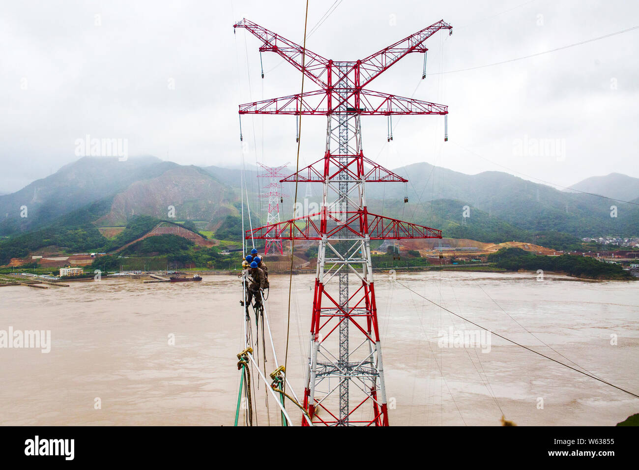 Chinese workers check on the Zhoushan 500 KV networking power ...