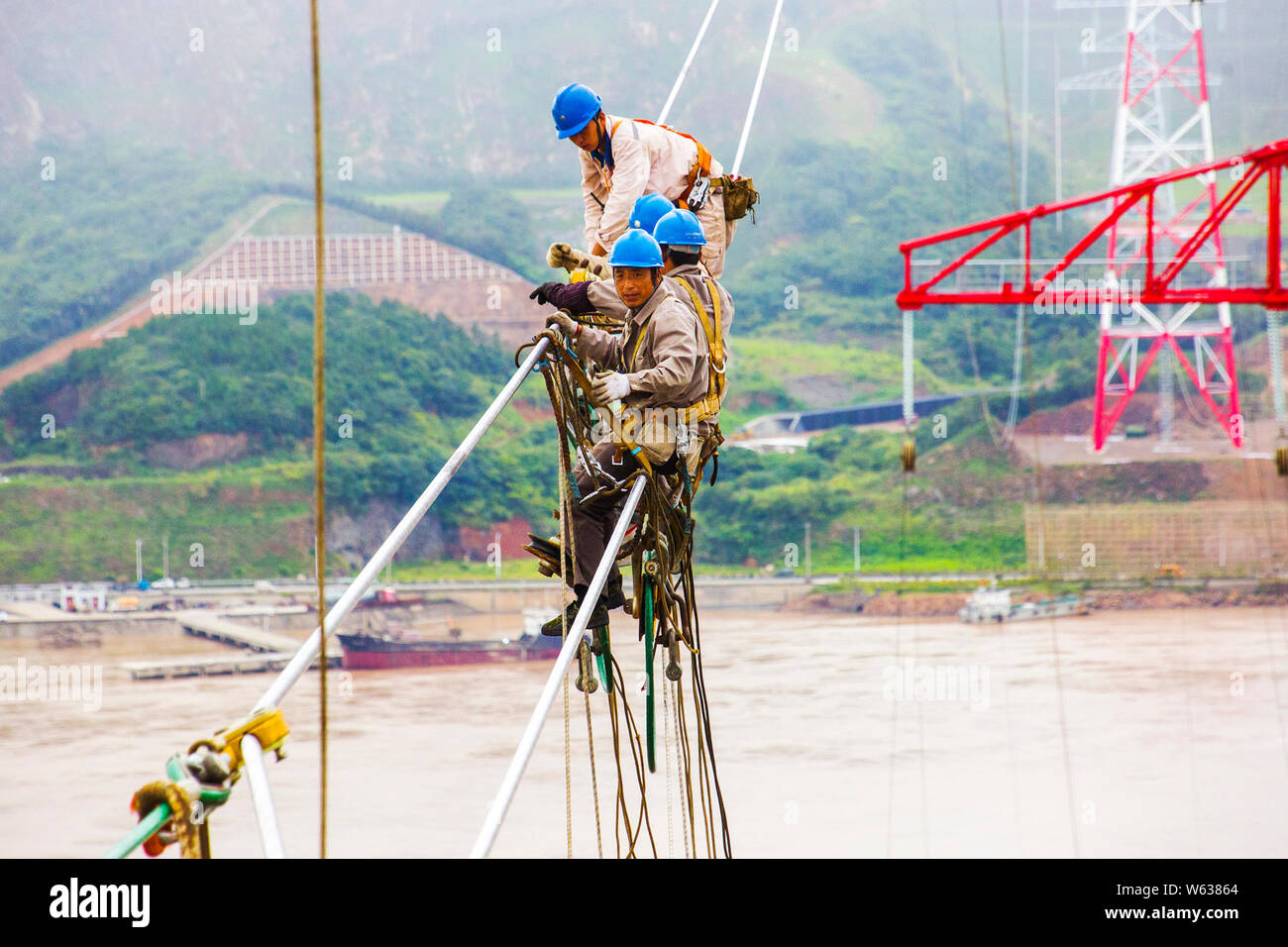 Chinese workers check on the Zhoushan 500 KV networking power ...