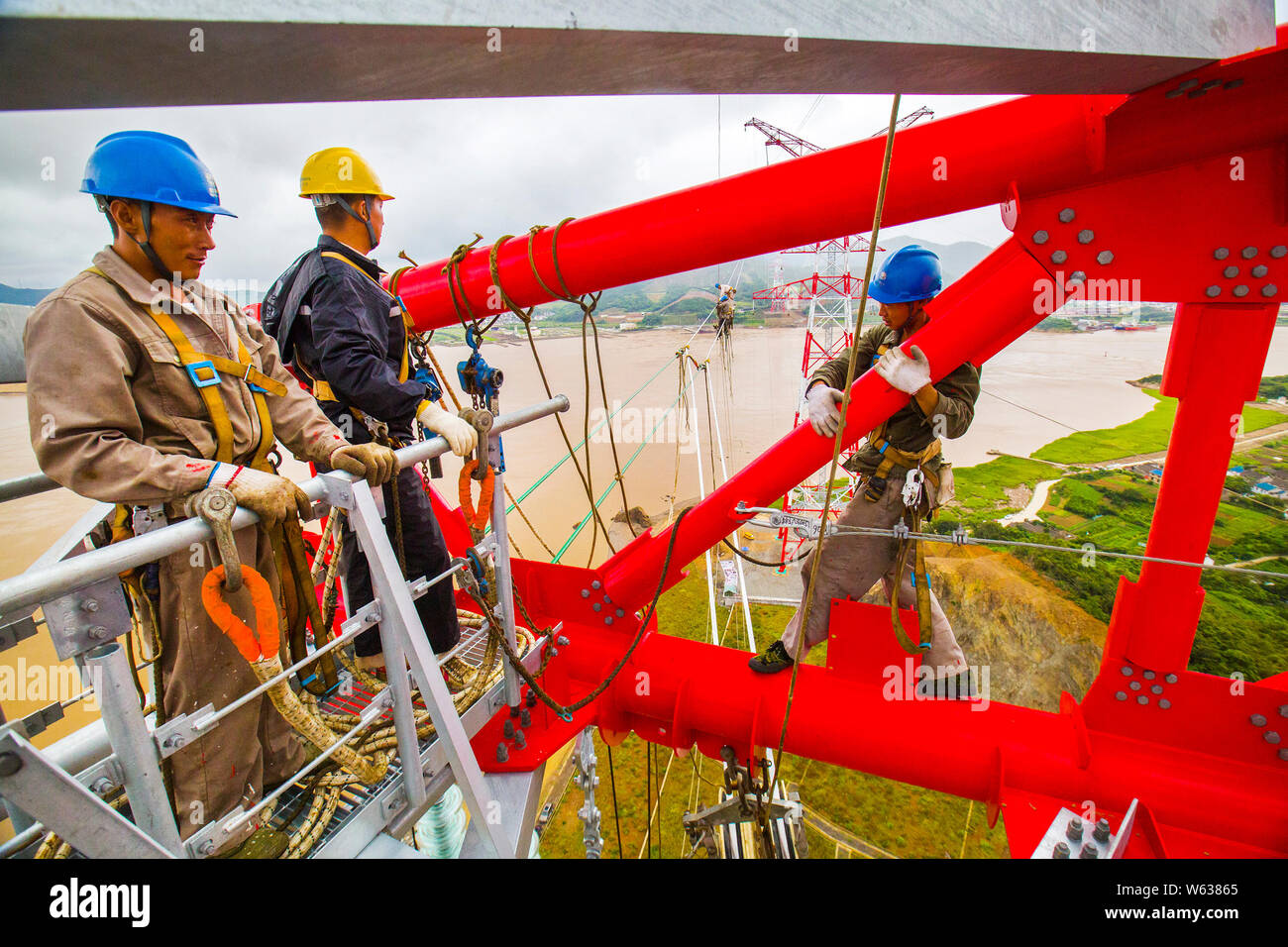 Chinese workers check on the Zhoushan 500 KV networking power ...