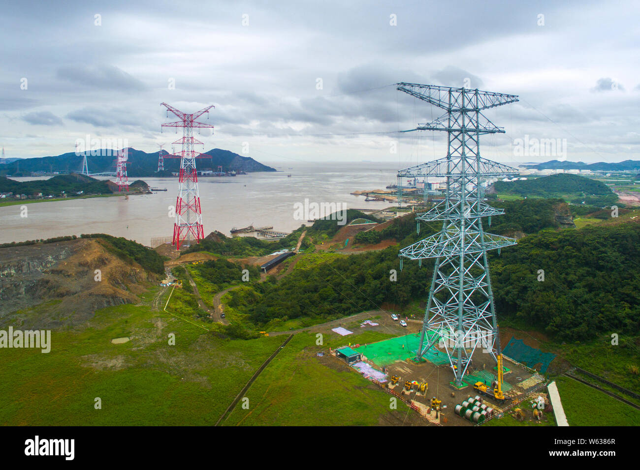 Chinese workers check on the Zhoushan 500 KV networking power ...