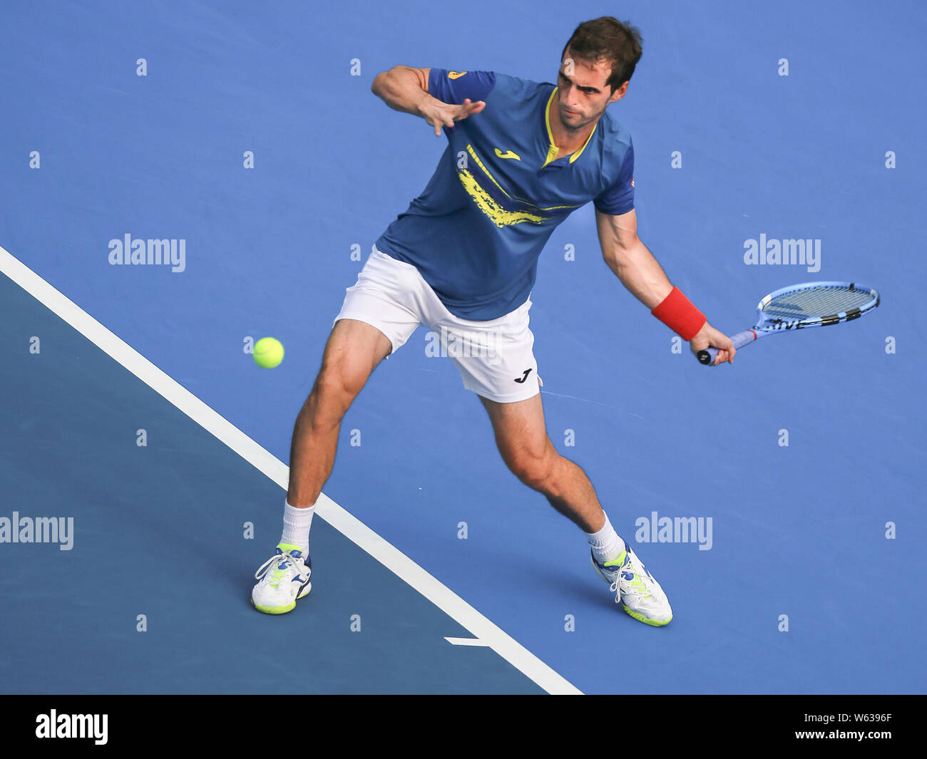 Albert Ramos Vinolas of Spain returns a shot to Viktor Troicki of ...