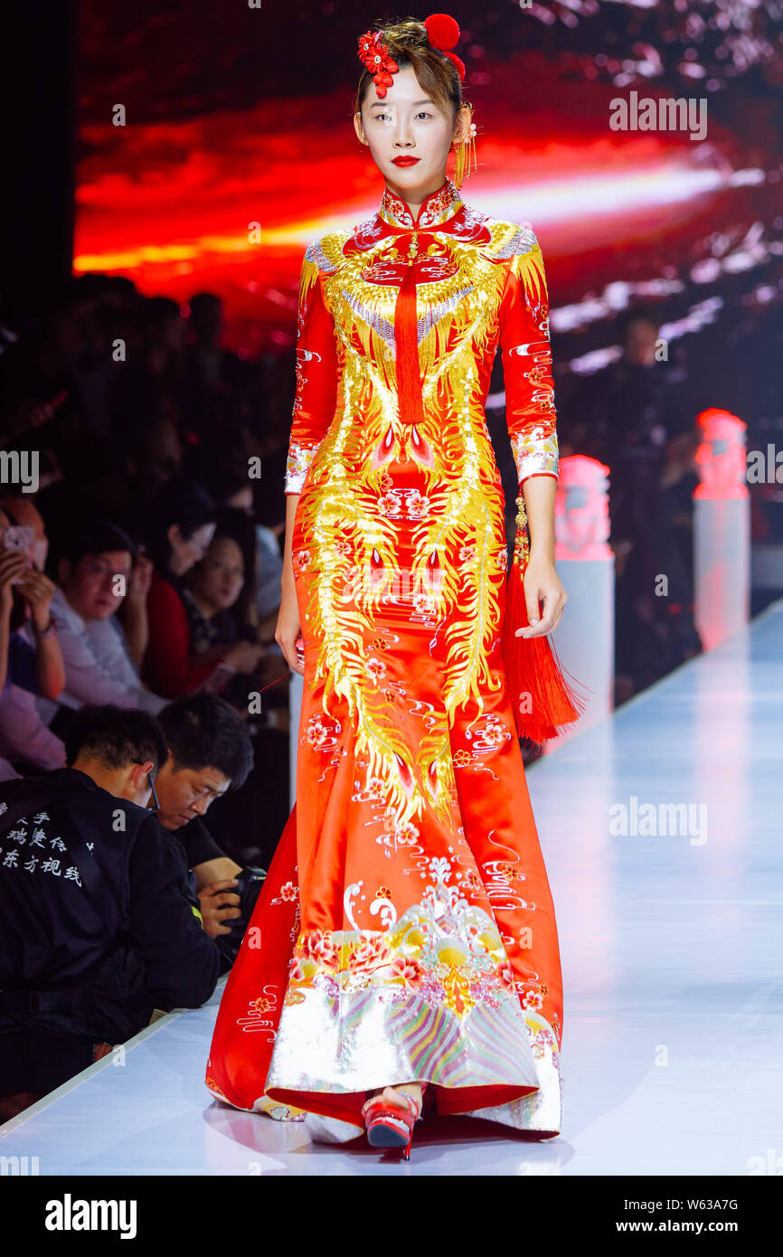 A model displays a new creation at an opera-themed fashion show during ...