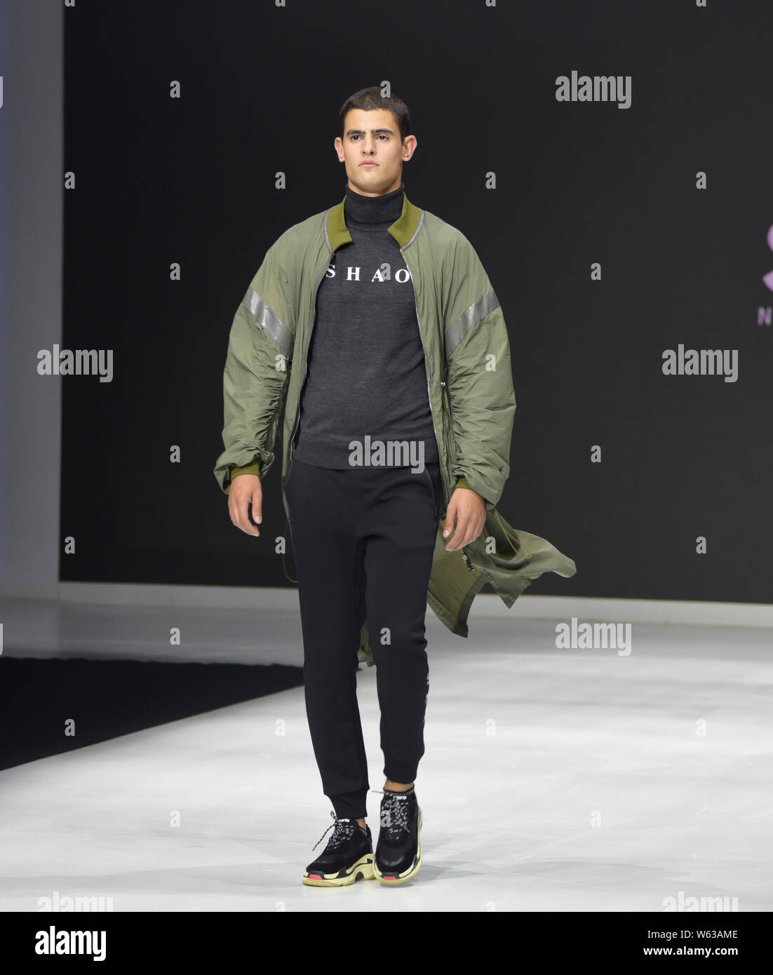 A model displays a new creation at the SHAO fashion show during the ...