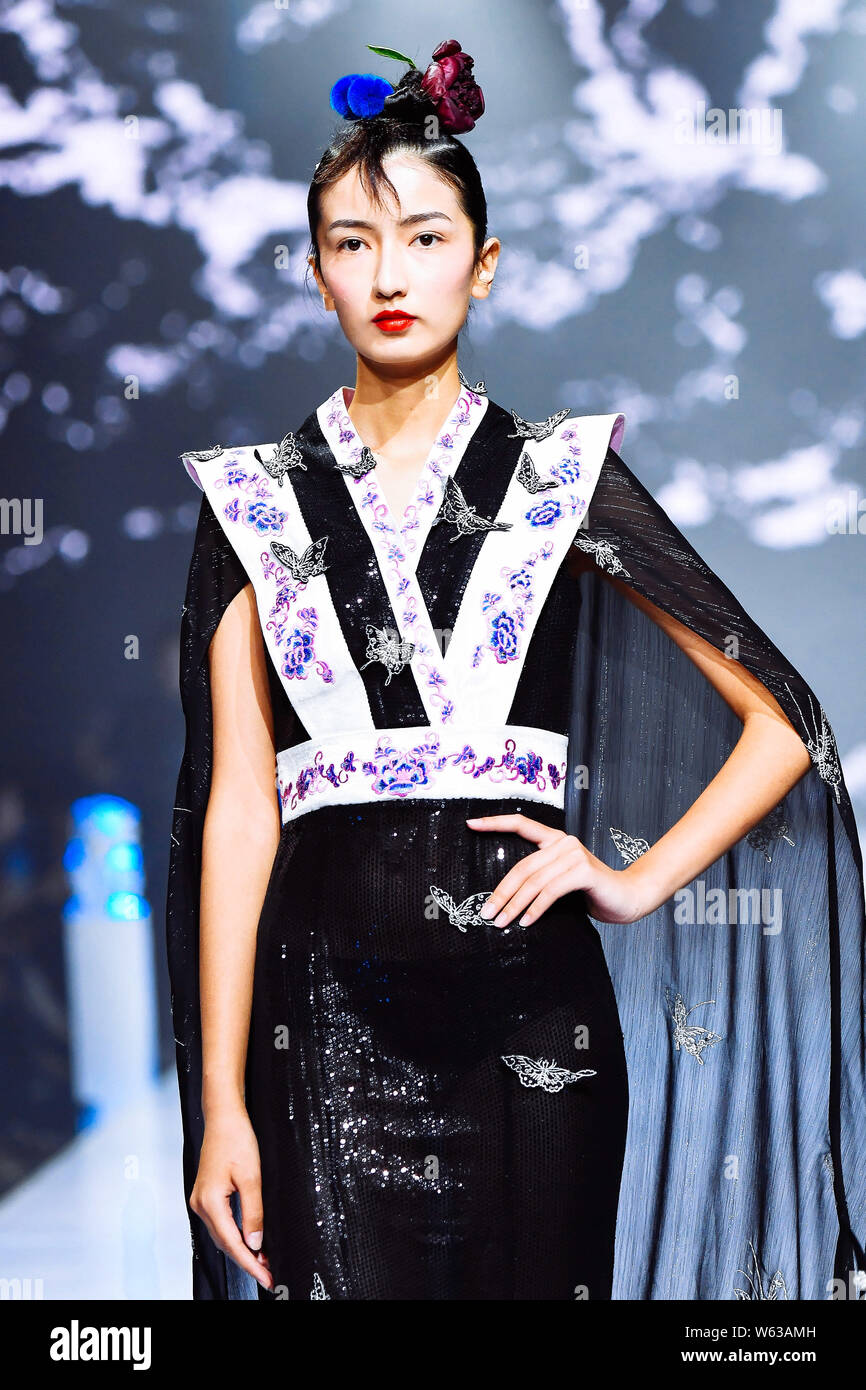 A model displays a new creation at an opera-themed fashion show during ...