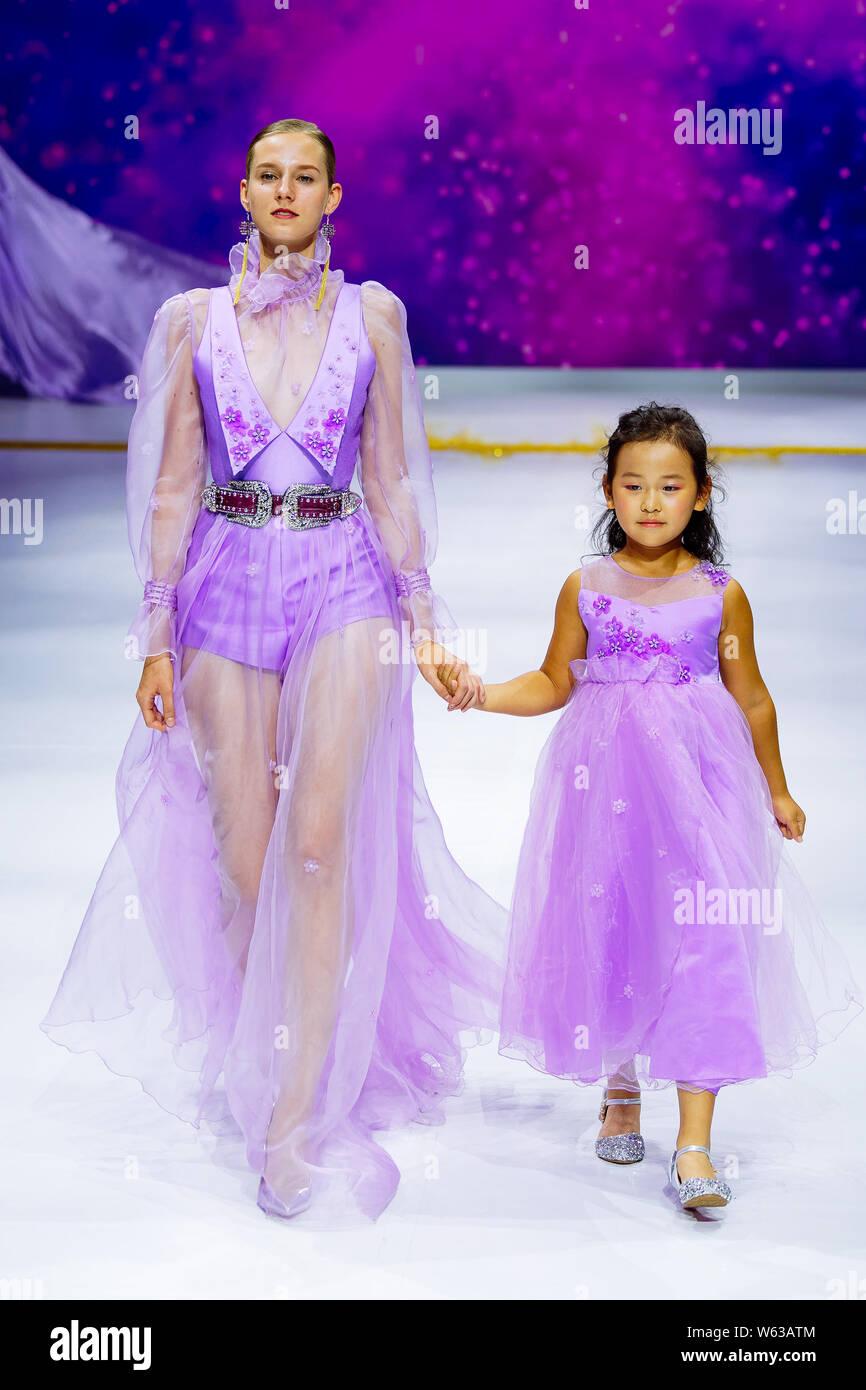 Models display traditional new creations at a fashion show during the ...