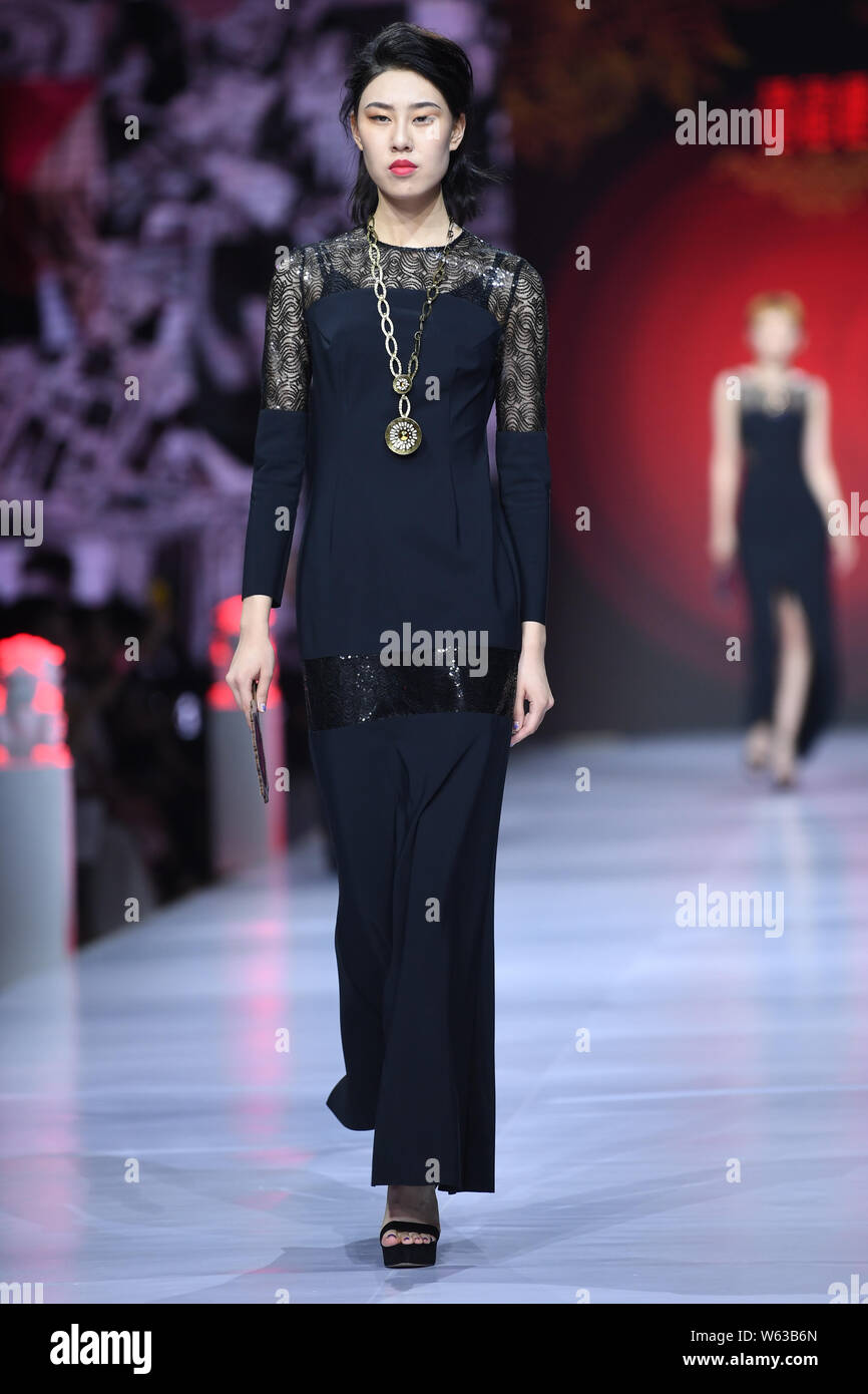 A model displays a new creation at the XIFUHUI fashion show during the ...