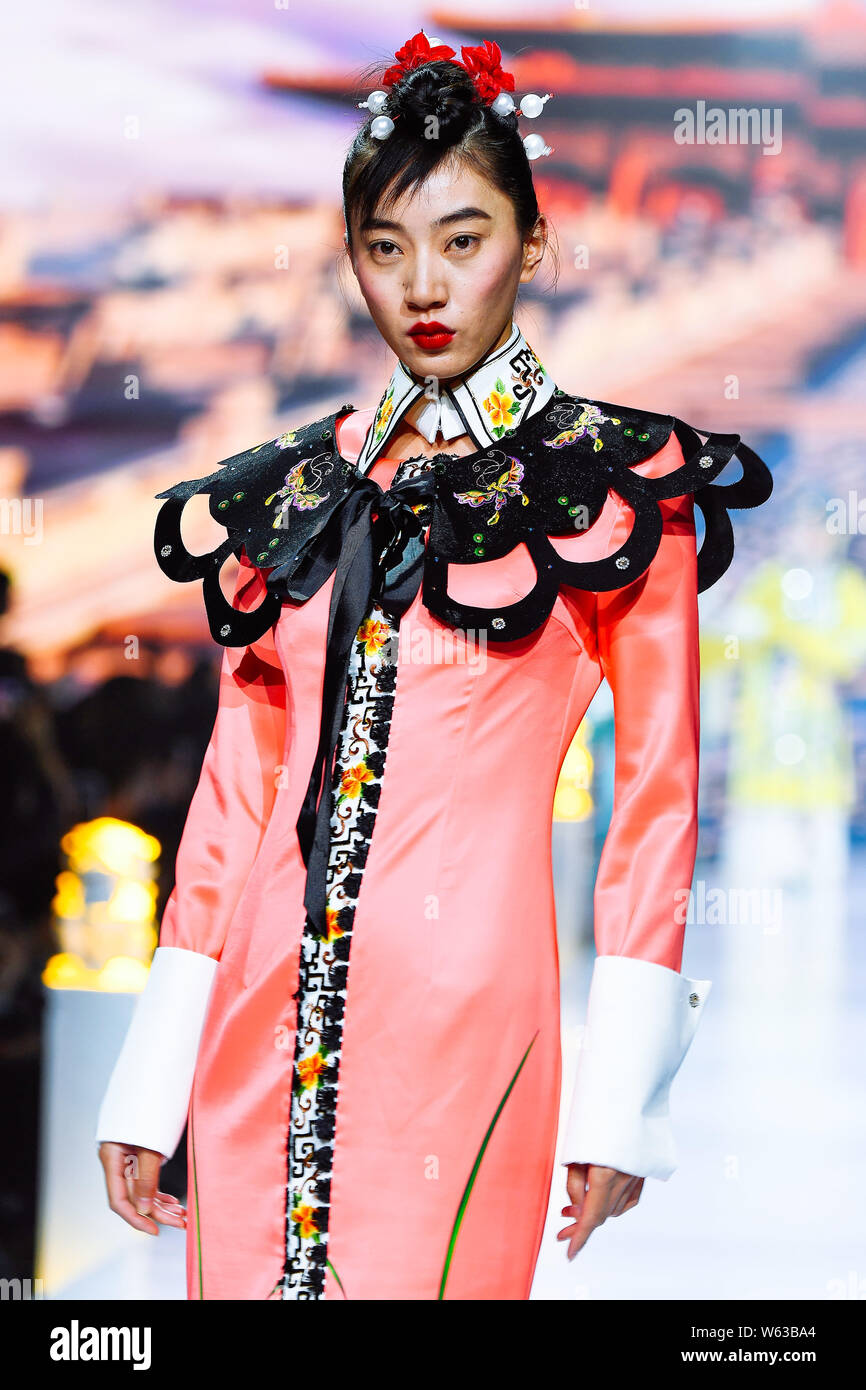 A model displays a new creation at an opera-themed fashion show during ...
