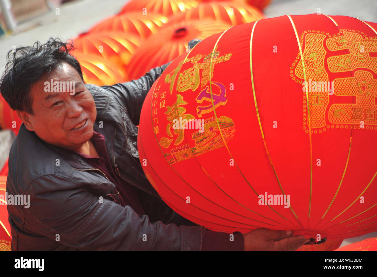 Chinese workers make red lanterns for the upcoming National Day at a ...