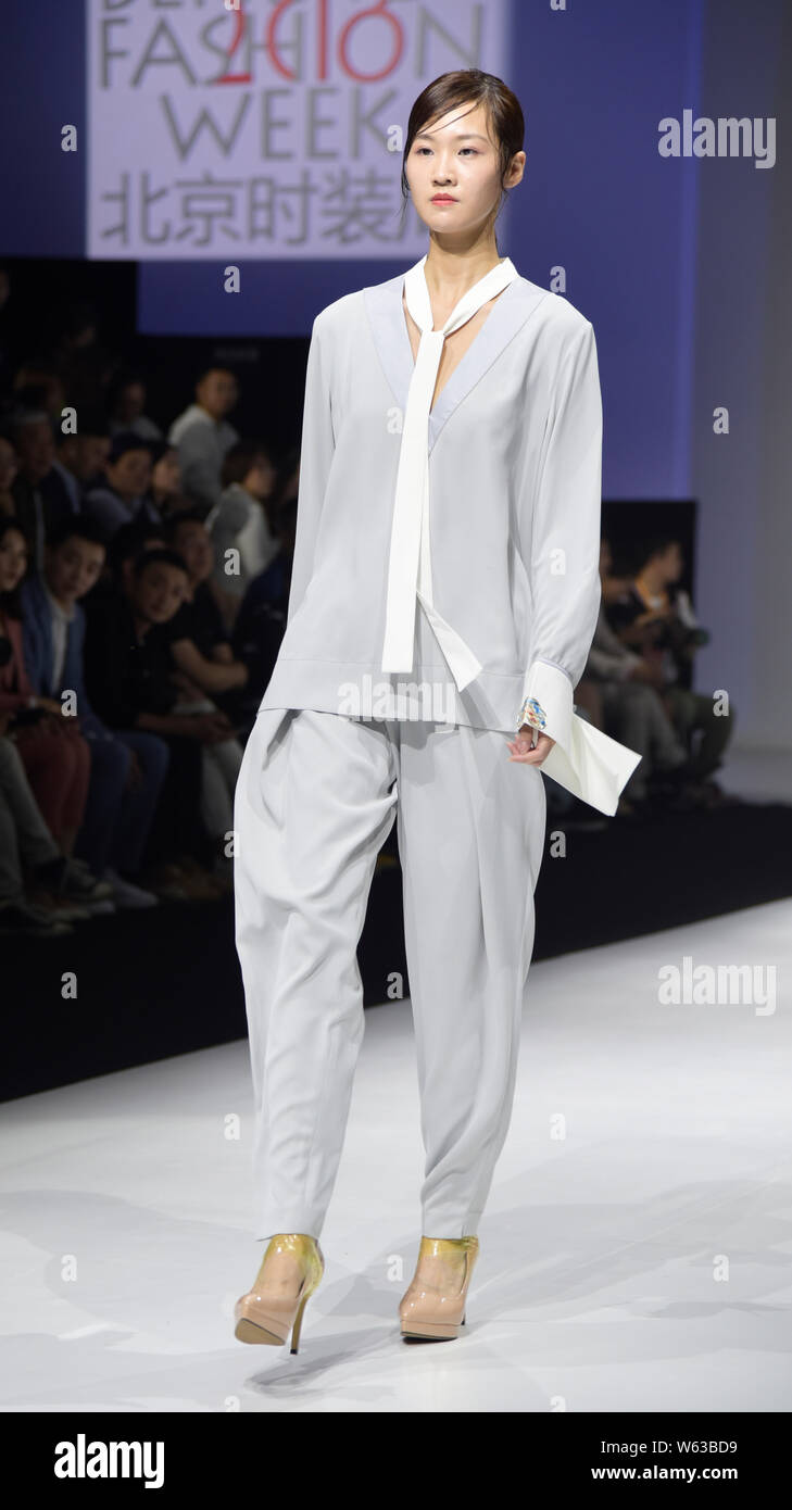 A model displays a new creation at the SHAO fashion show during the ...