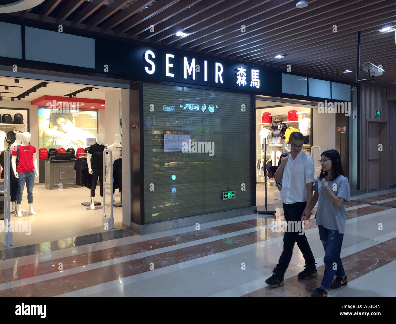 --FILE--Citizens walk past a Semir store in Wuhan city, central China's ...