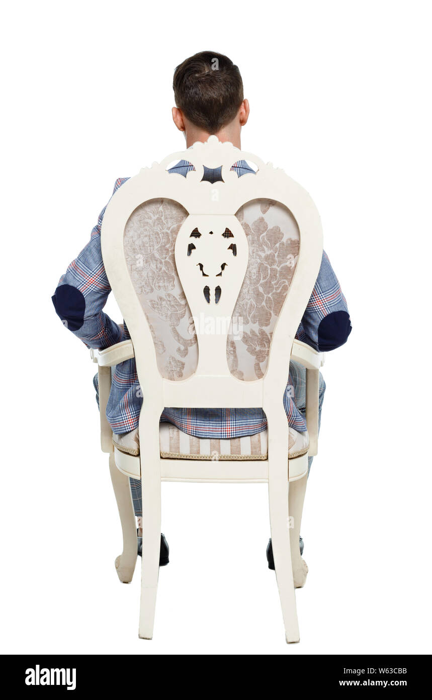 Back view of man in a suit is sitting on an expensive chair. Isolated ...
