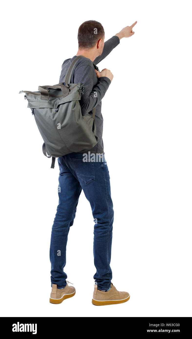 Back view of a man with a green backpack pointing forward. backside ...