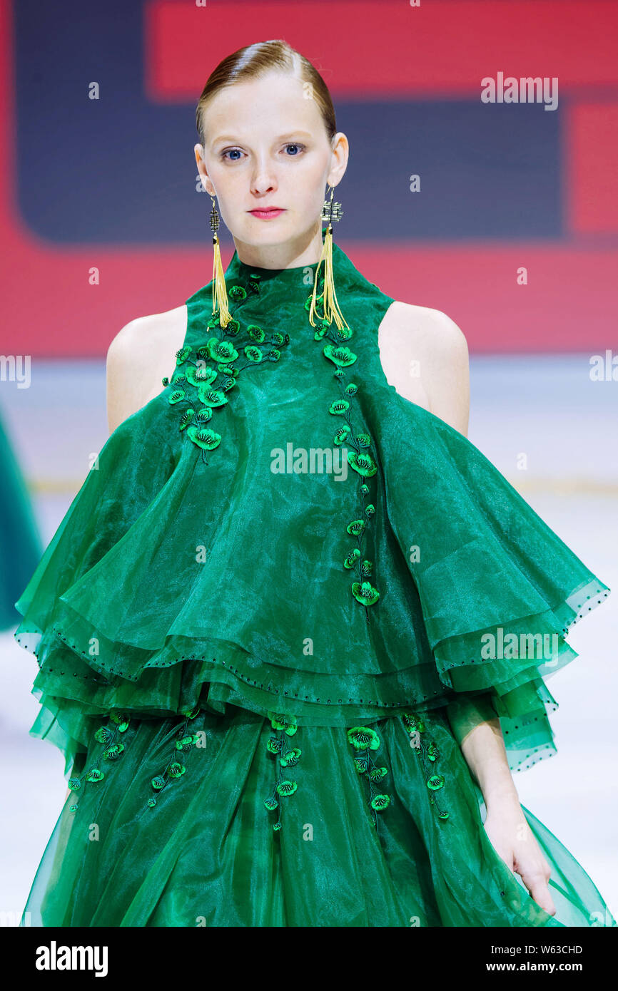 A model displays a traditional new creation at a fashion show during ...