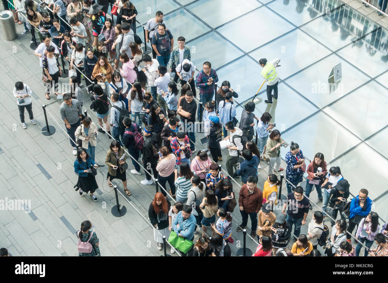 Chinese customers queue up to buy cheese tea at a branch of HEYTEA, a ...