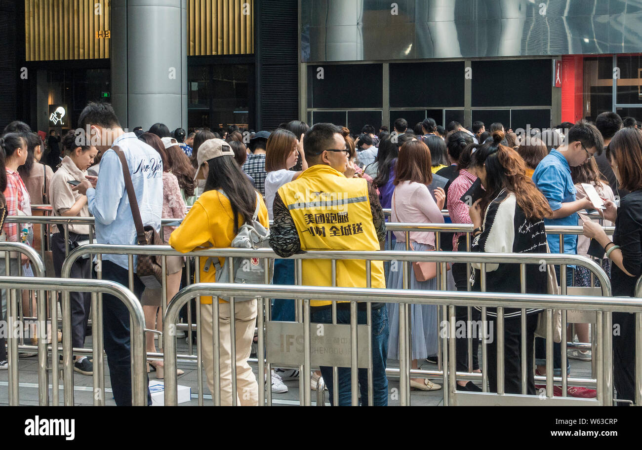 Chinese customers queue up to buy cheese tea at a branch of HEYTEA, a ...