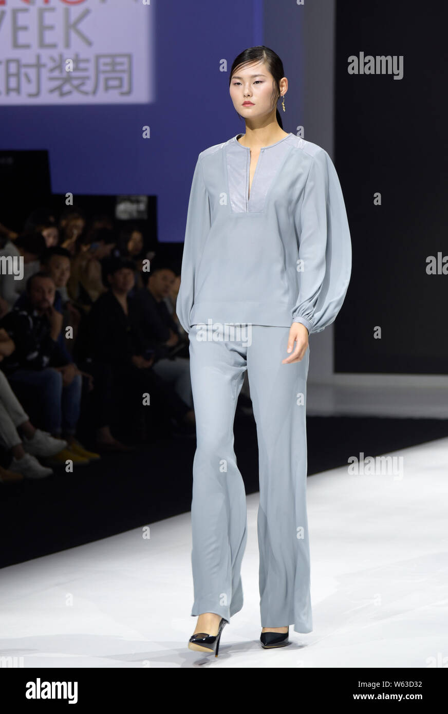 A model displays a new creation at the SHAO fashion show during the ...