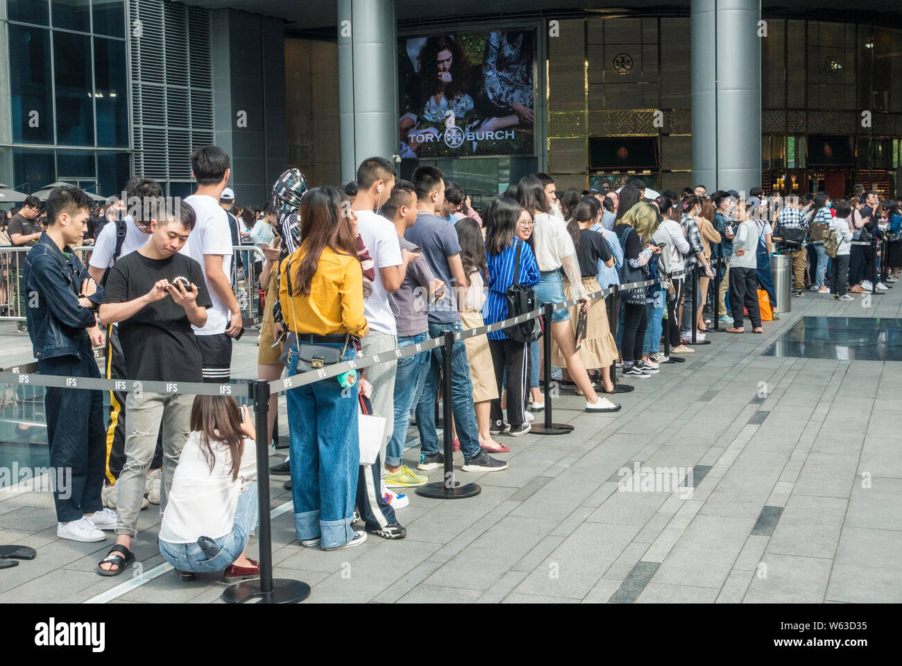 Chinese customers queue up to buy cheese tea at a branch of HEYTEA, a ...