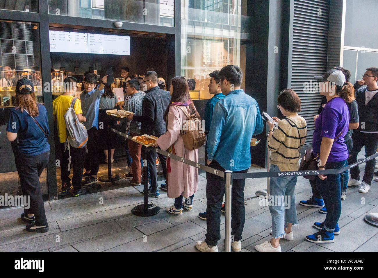 Chinese customers queue up to buy cheese tea at a branch of HEYTEA, a ...