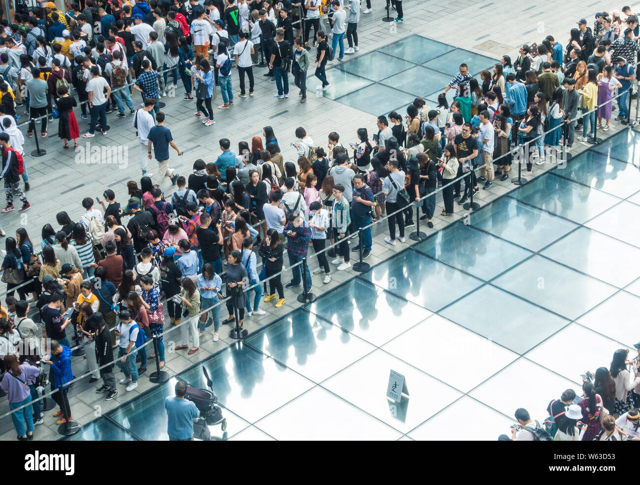 Chinese customers queue up to buy cheese tea at a branch of HEYTEA, a ...