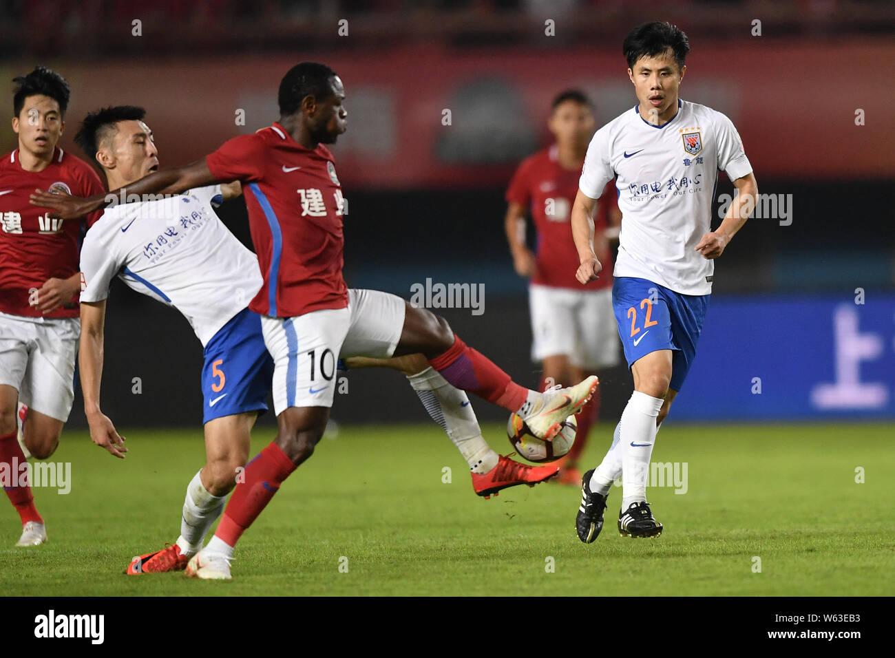 Cameroonian soccer player Christian Bassogog, center, of Henan Jianye ...