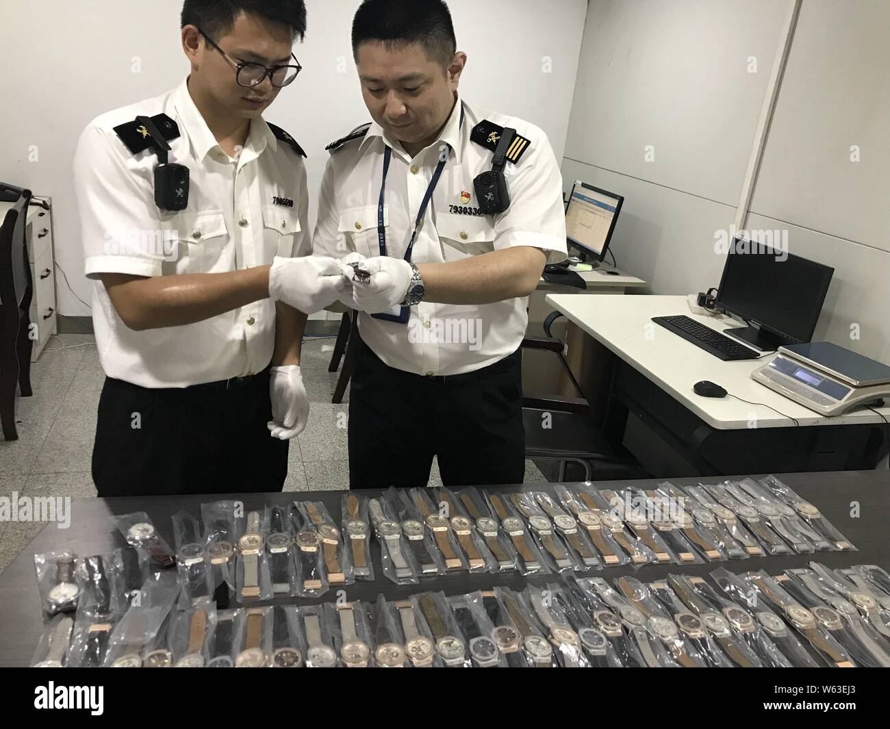 In this undated photo, Chinese customs officers show counterfeit ...