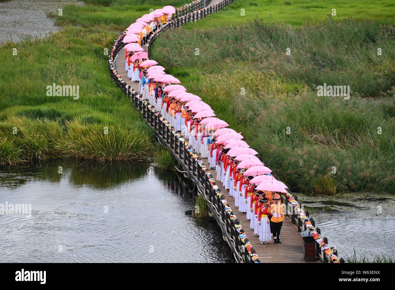 66 couples dressed in Mosuo people's traditional clothing take part in ...