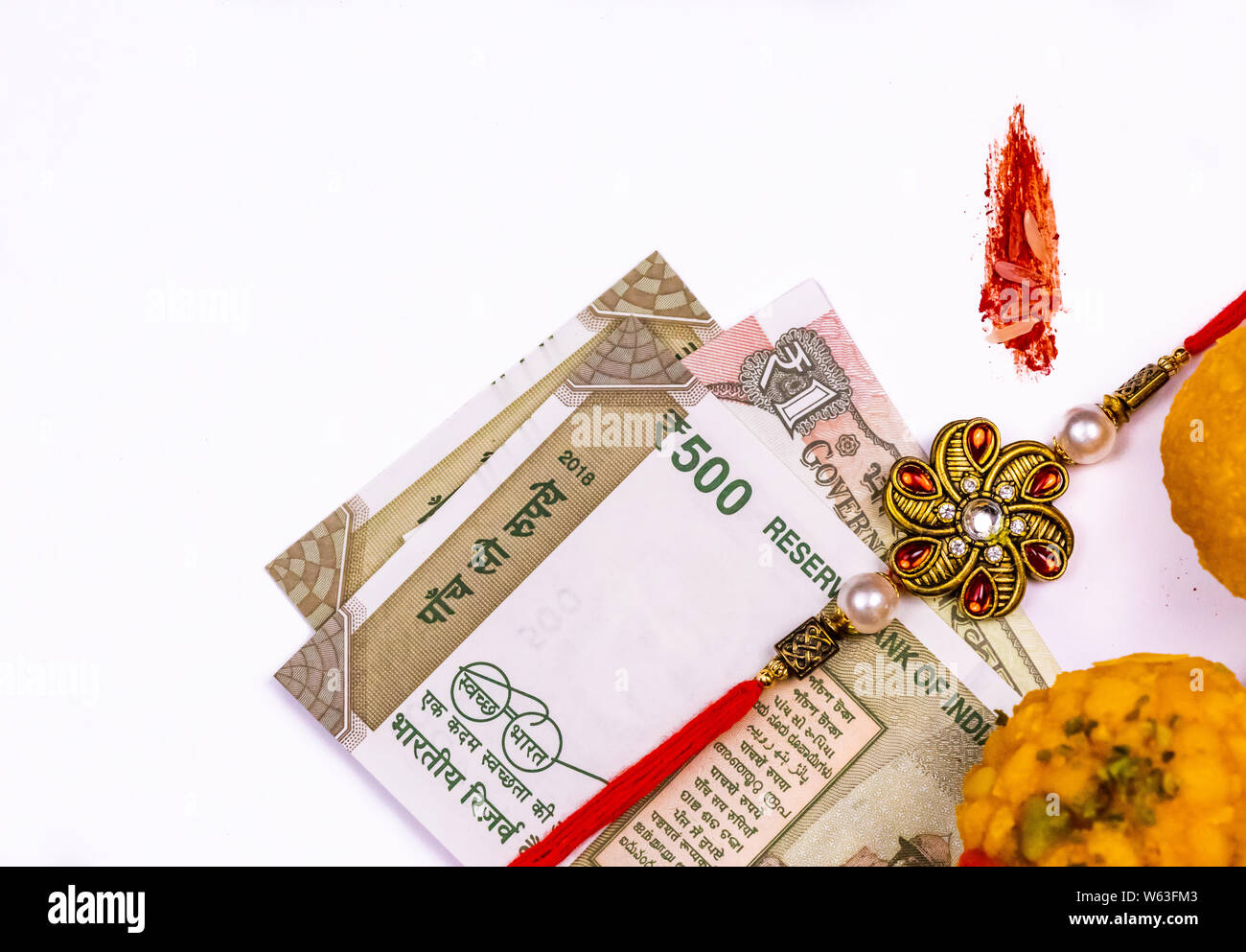 Raksha Bandhan concept - Elegant Rakhi with Indian currency, sweets and ...
