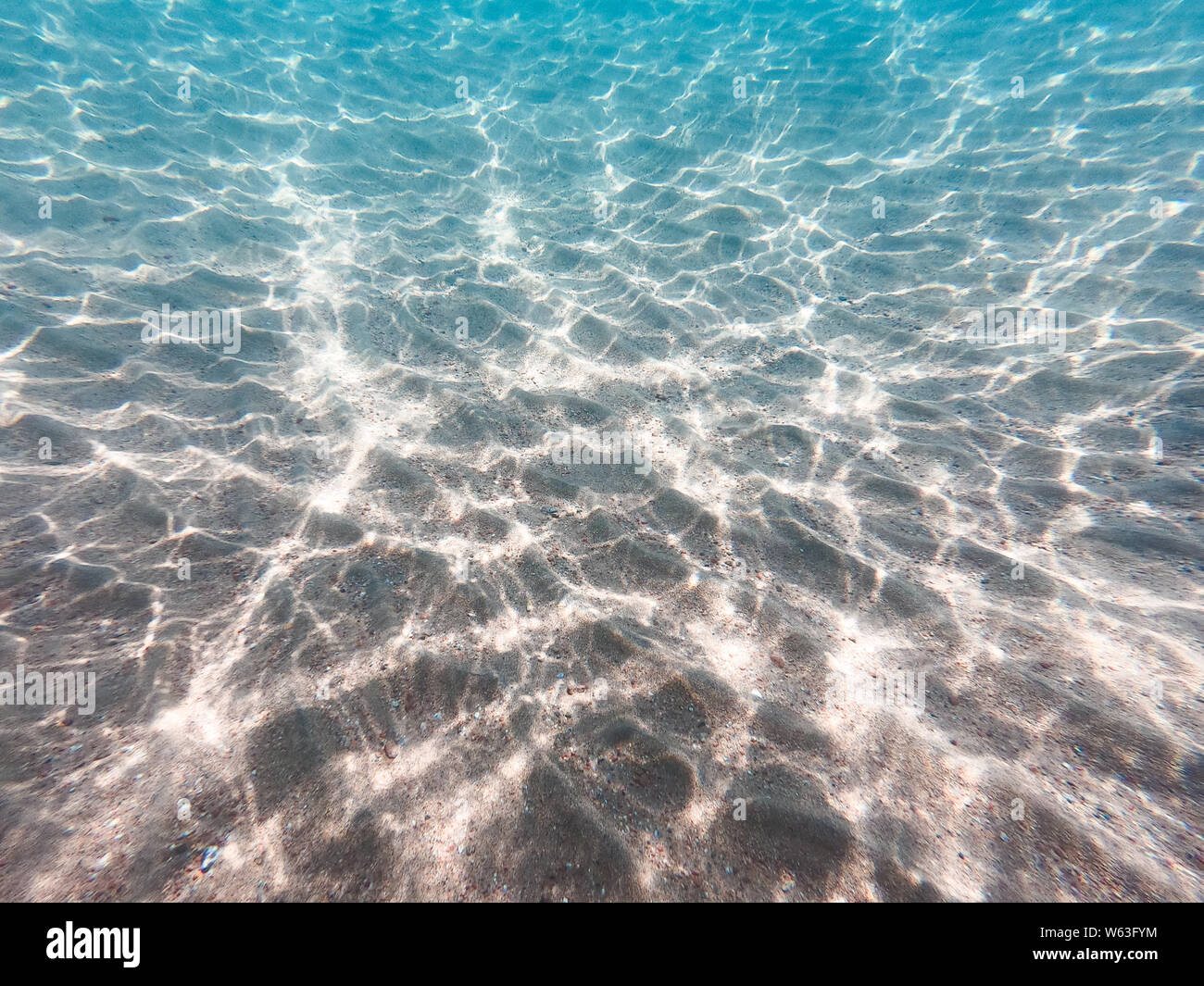 underwater background with sandy sea bottom. Beautiful texture of the ...