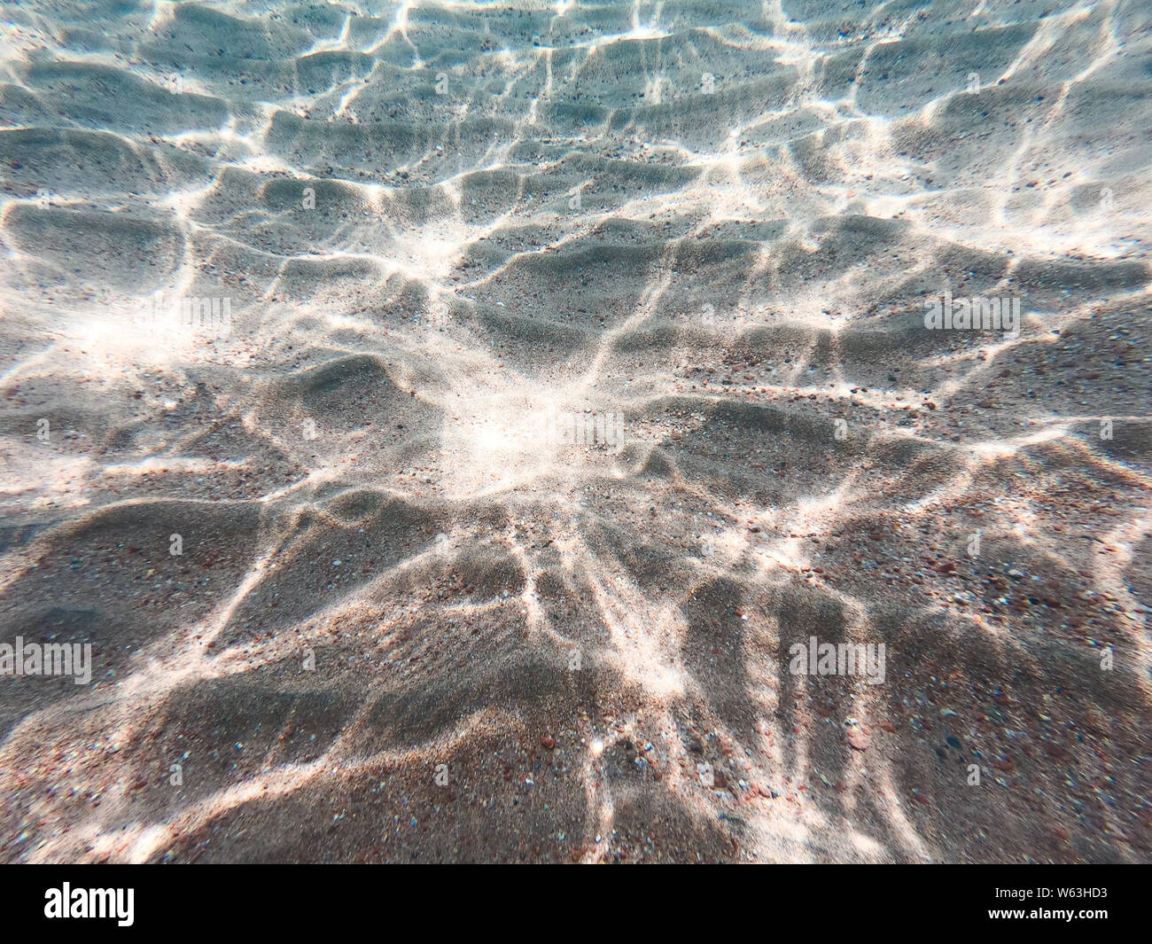 underwater background with sandy sea bottom. Beautiful texture of the ...