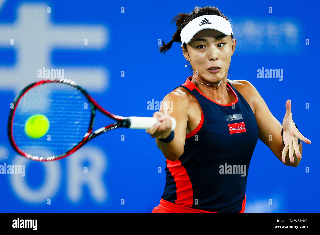Wang Qiang of China returns a shot to Maria Sakkari of Greece in their ...
