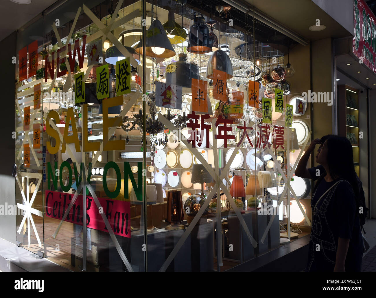 Windows of a building are taped up in preparation for the Typhoon ...
