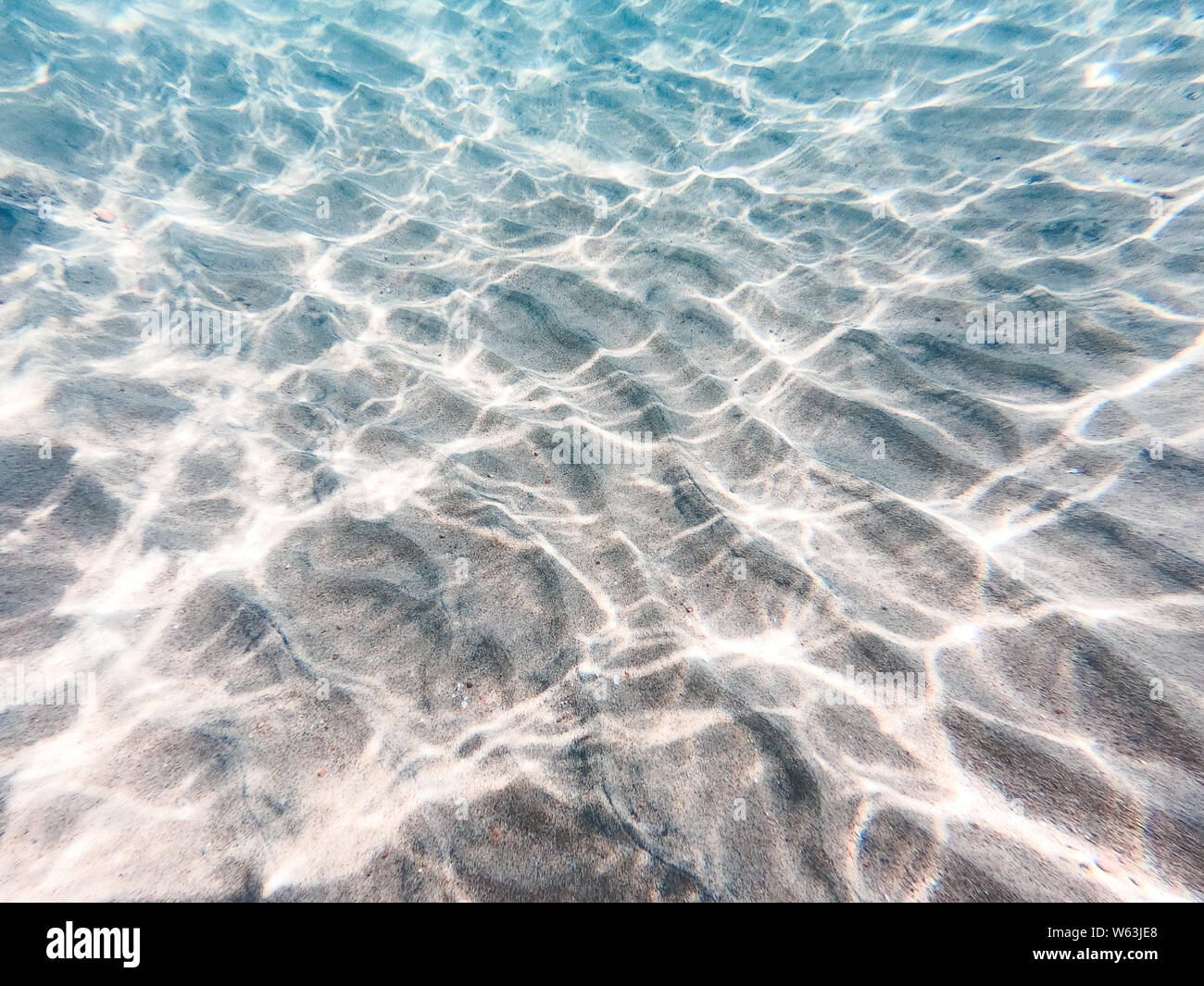 underwater background with sandy sea bottom. Beautiful texture of the ...