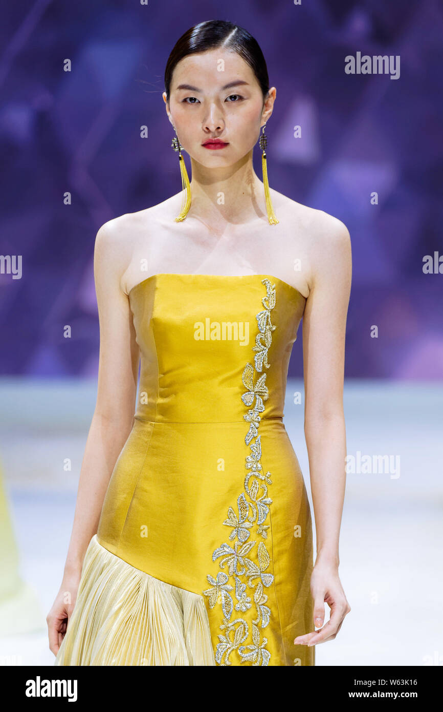 A model displays a traditional new creation at a fashion show during ...