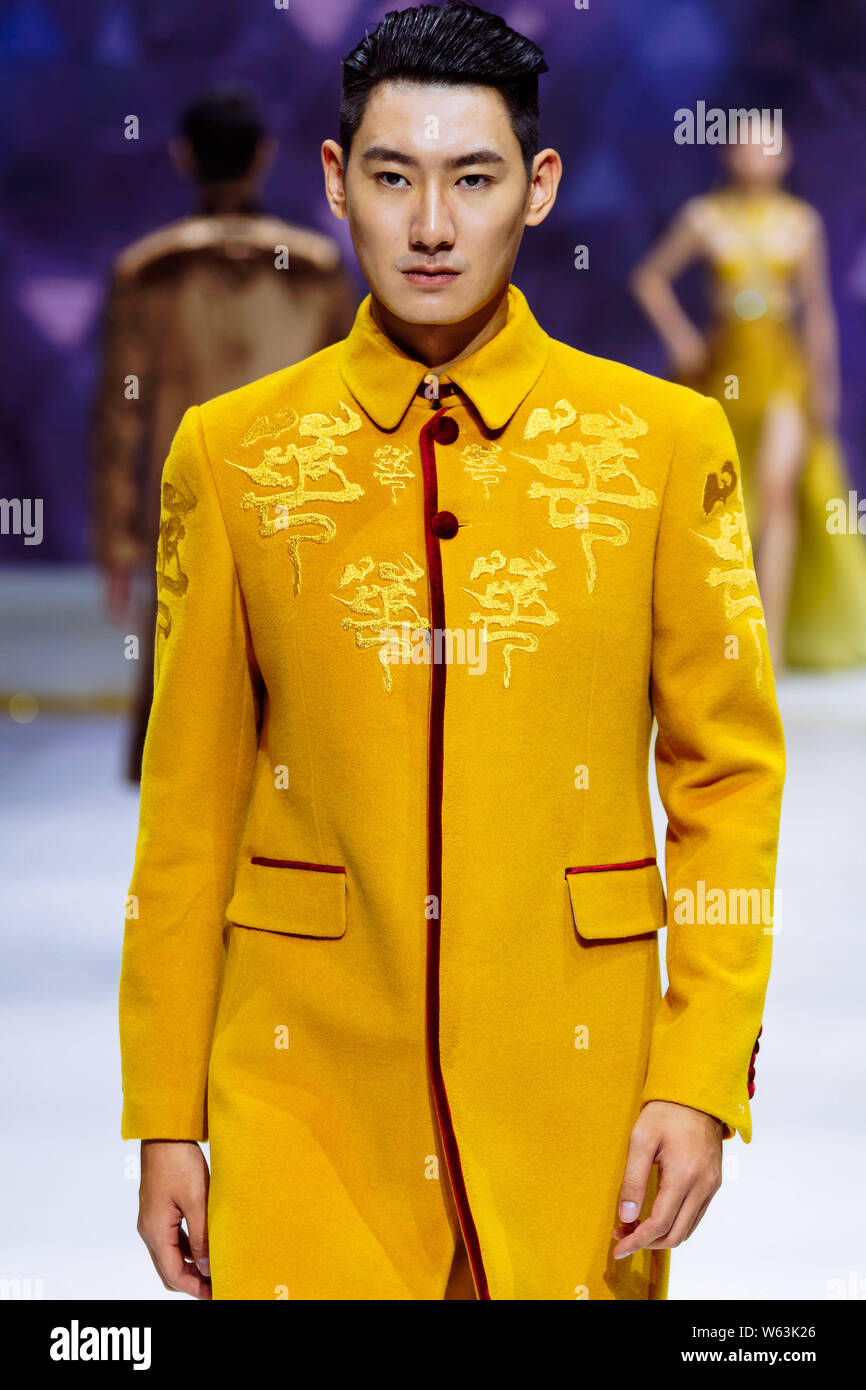 A model displays a traditional new creation at a fashion show during ...