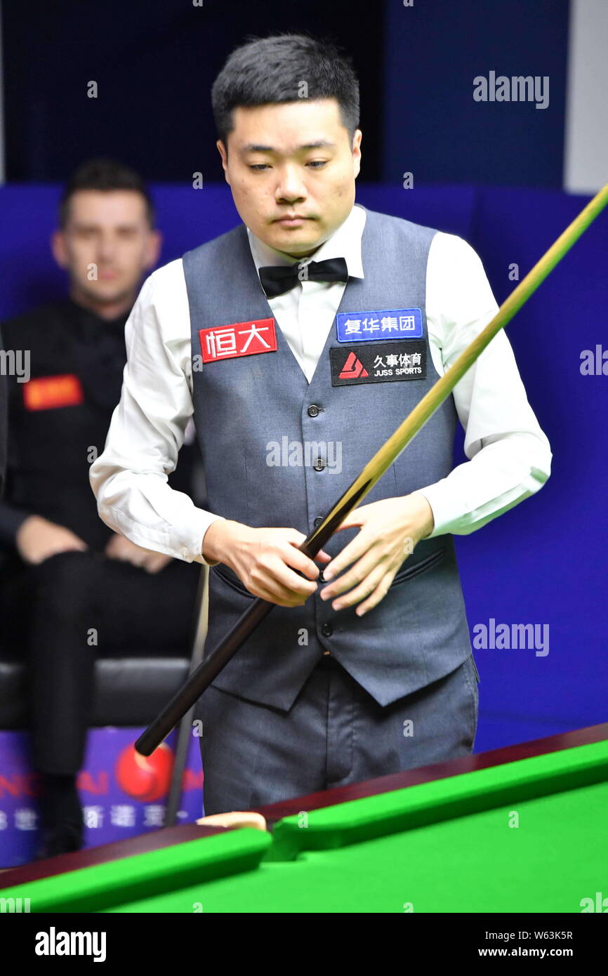 Ding Junhui of China considers a shot to Mark Selby of England in their ...