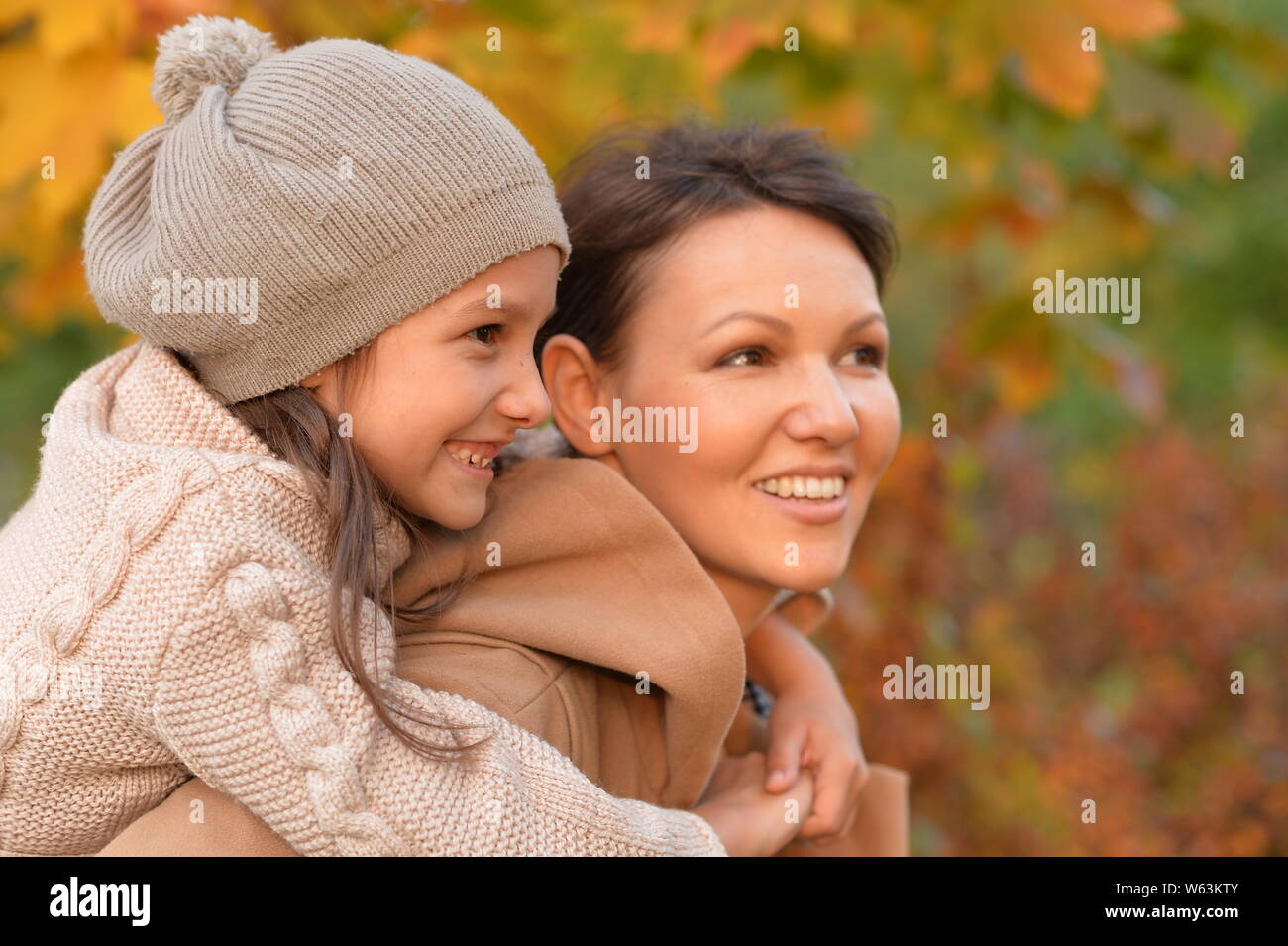 Portrait of young mother and daughter hugging Stock Photo - Alamy