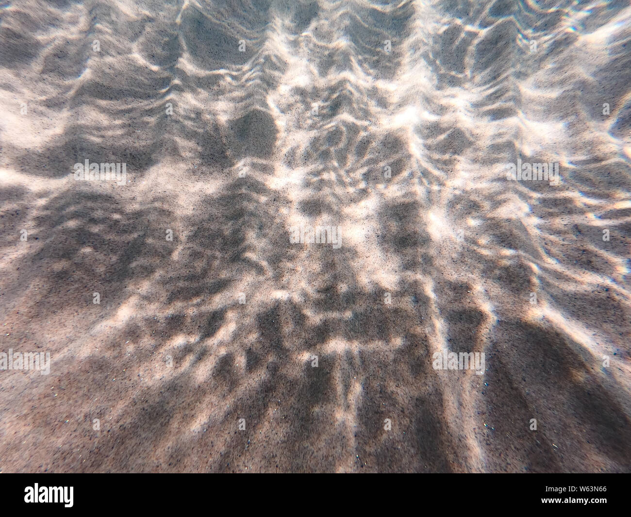 underwater background with sandy sea bottom. Beautiful texture of the ...