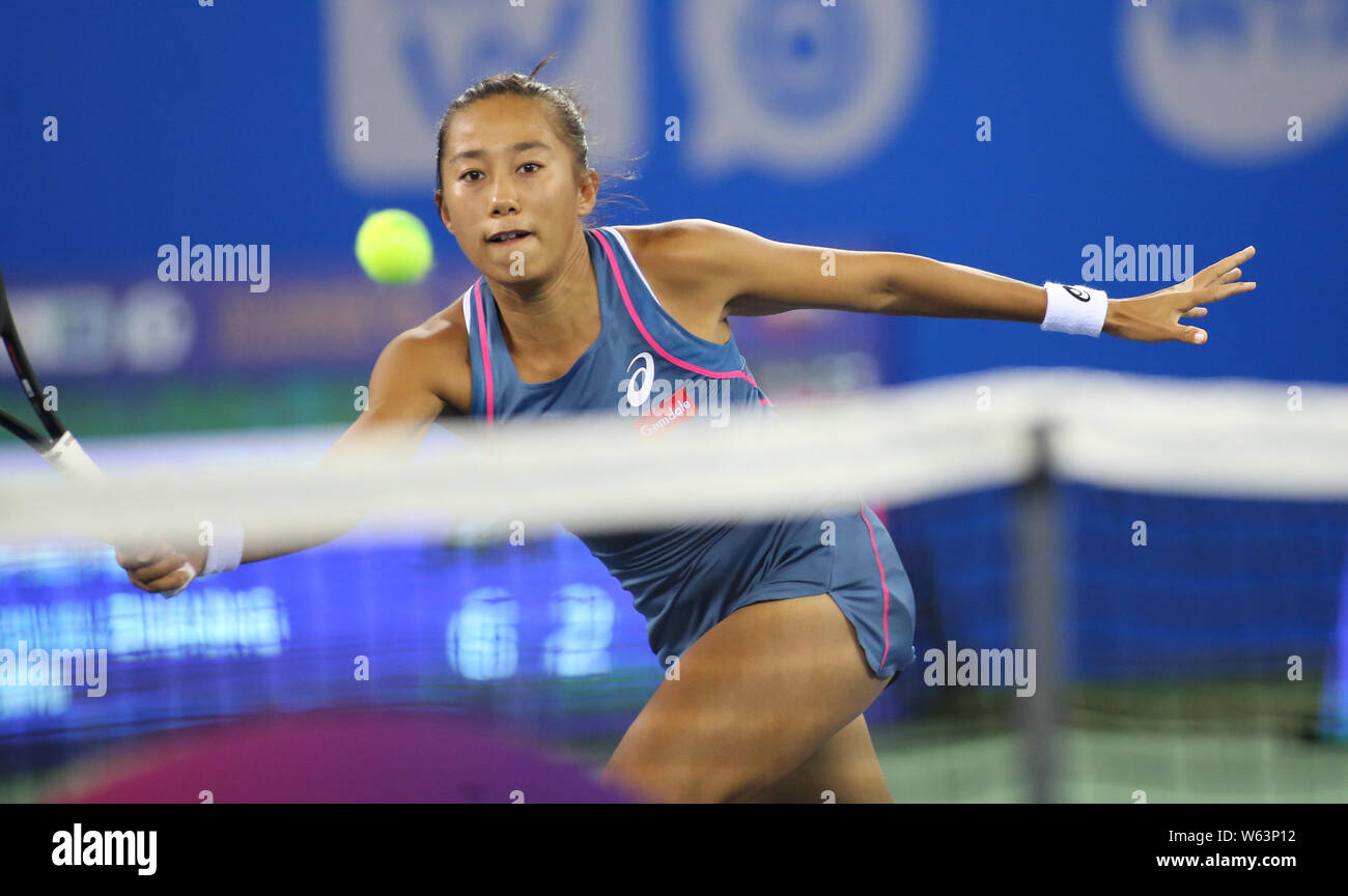 Zhang Shuai of China returns a shot to Samantha Stosur of Australia in ...