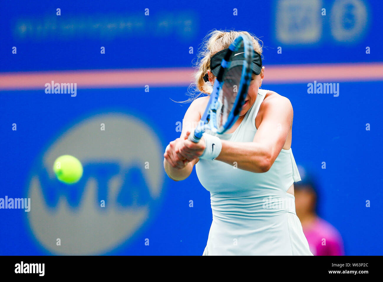 Amanda Anisimova of United States returns a shot to Wang Yafan of China ...