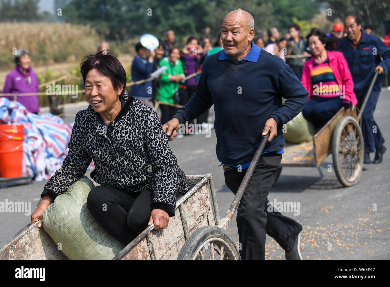 Chinese farmers cart their wives and stuffed sacks in the wife-carting ...