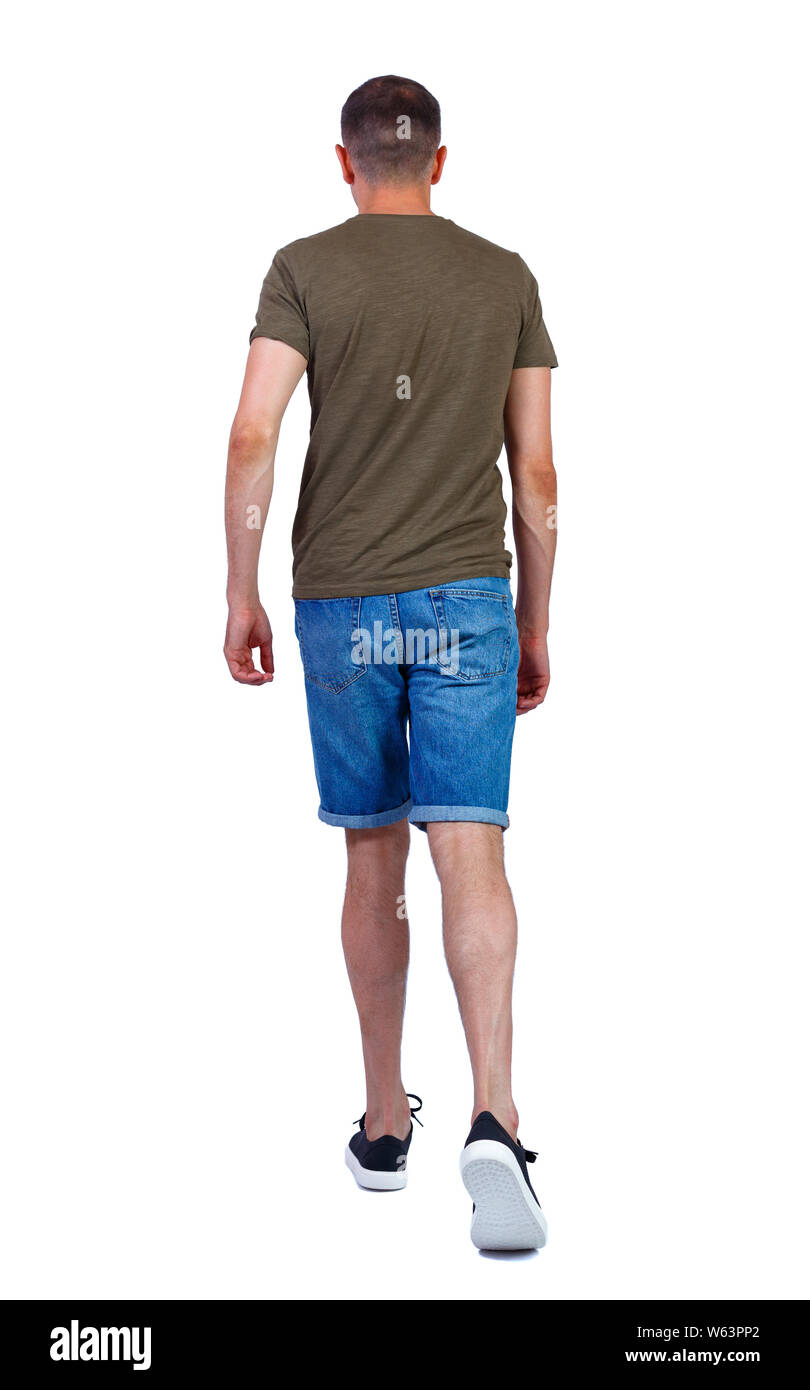 Back view of going handsome man in shorts. walking young guy . Rear ...