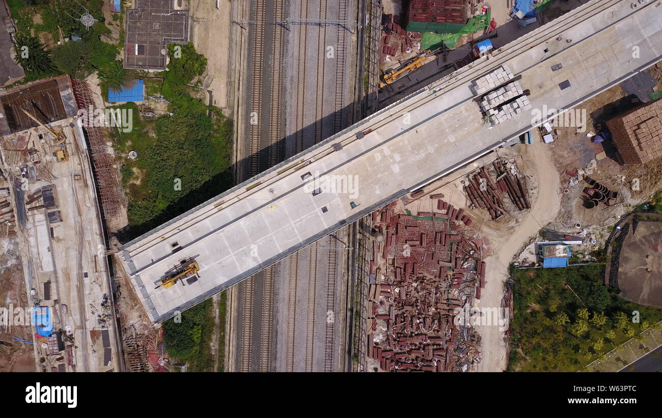 An 18,000-tonne box girder bridge is rotating 120 degrees over a ...