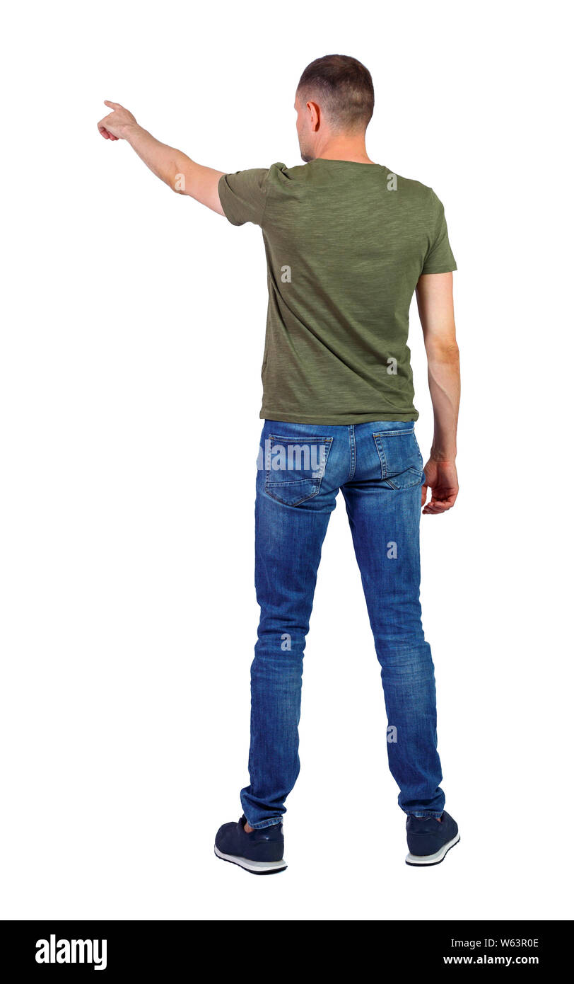 Back view of a man in jeans points his hand upwards. Rear view people ...