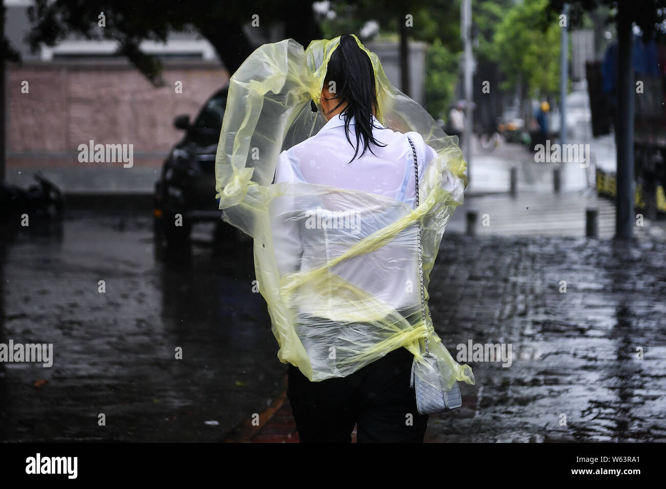 Raincoat wind hi-res stock photography and images - Alamy