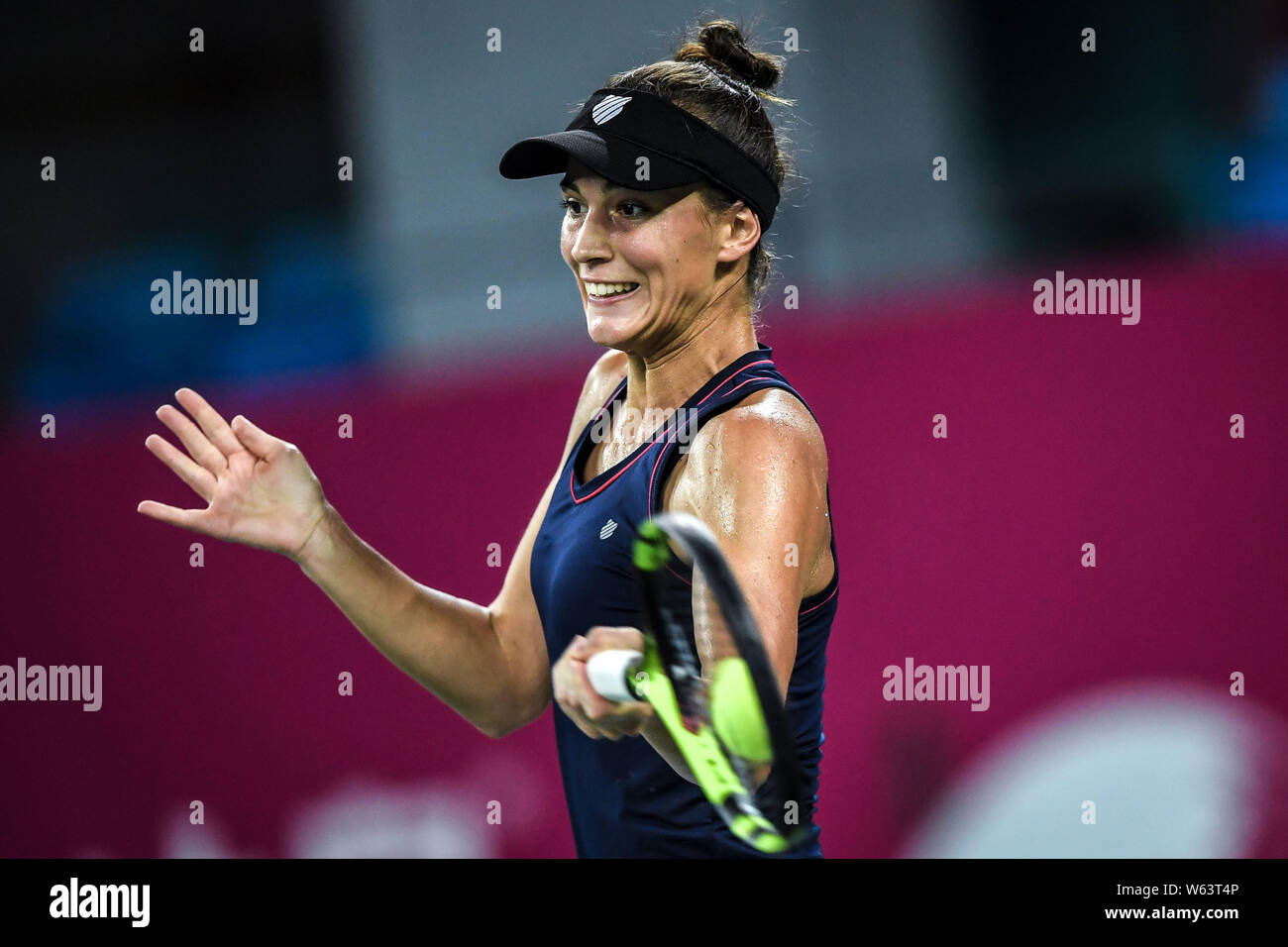Bernarda Pera of the USA returns a shot to Yulia Putintseva of ...